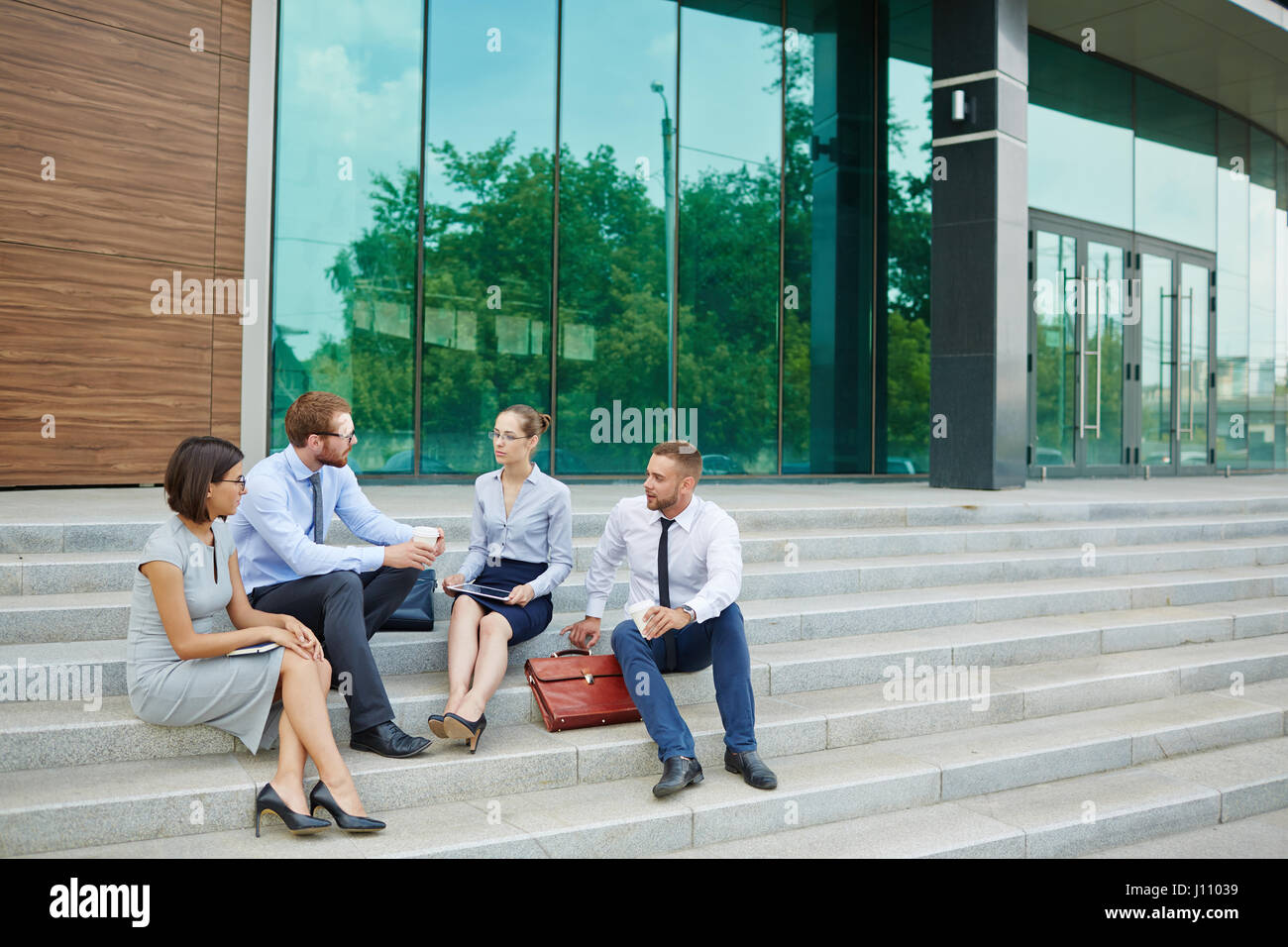 Group of people sitting on steps hi-res stock photography and images ...