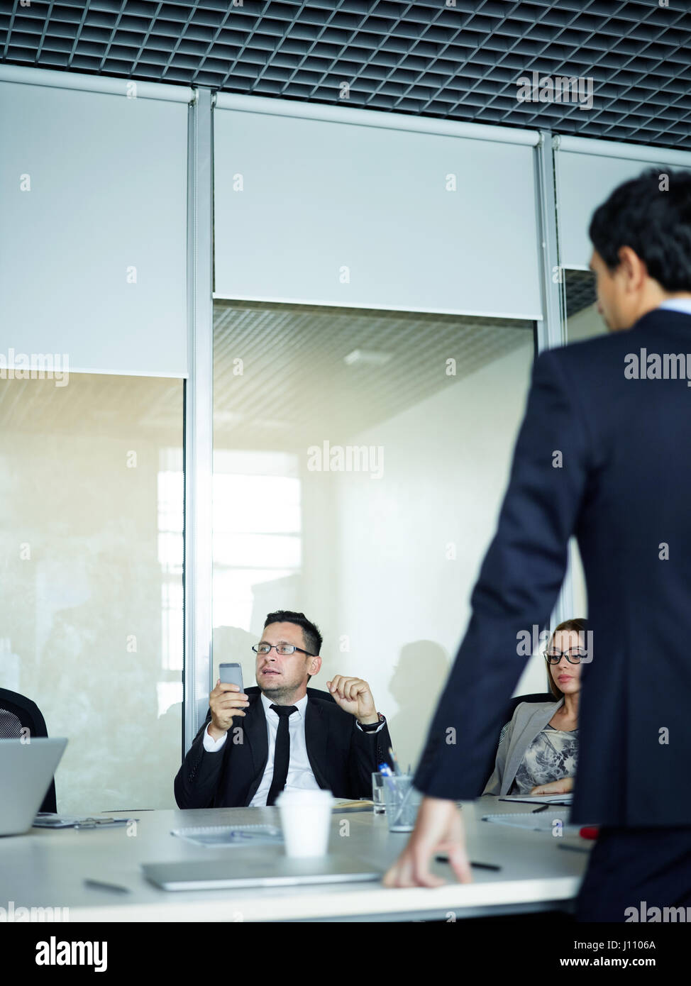 Group of business people discussing business problems at meeting table ...
