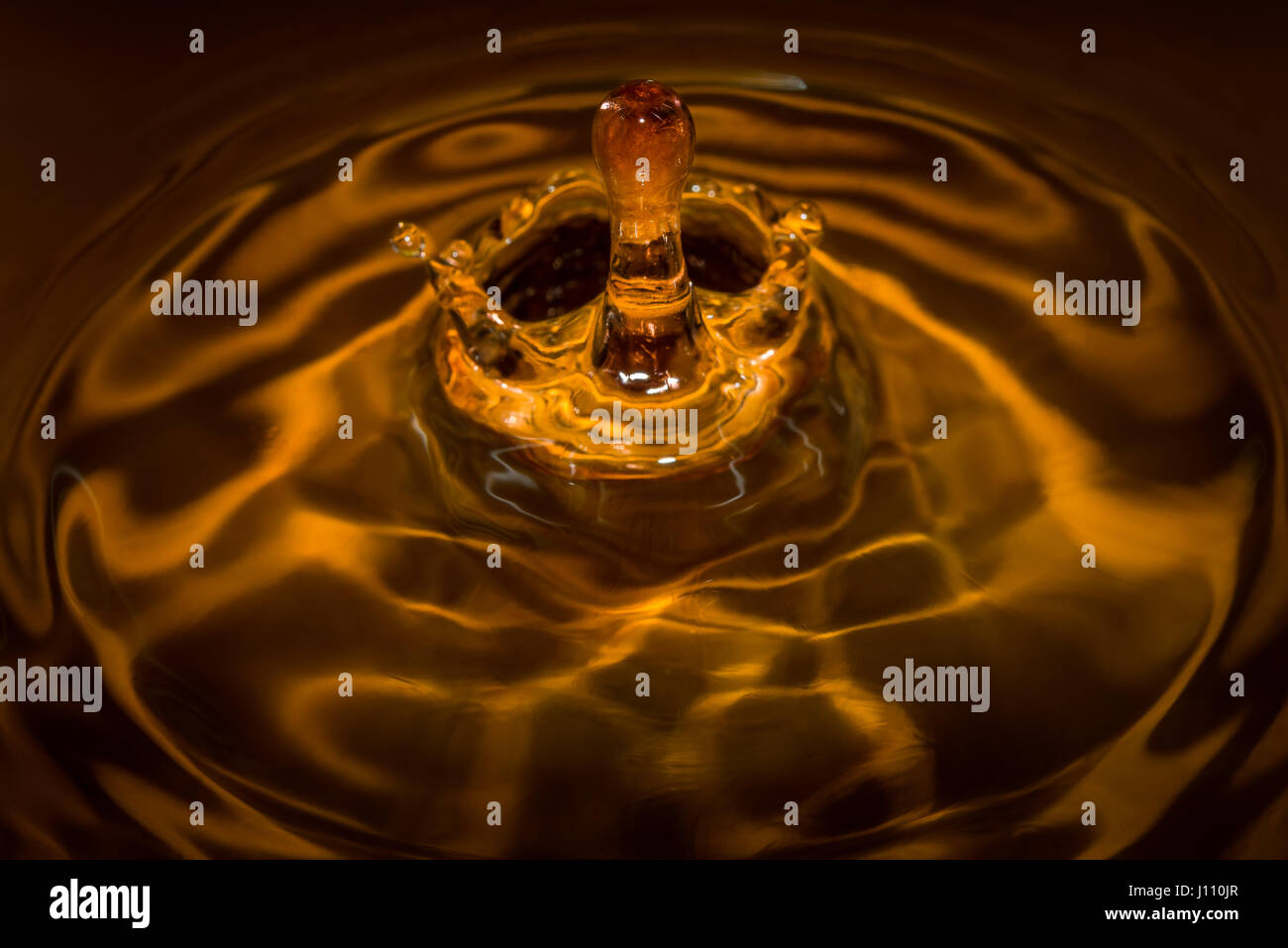 Red water drop an waves with yellow background and reflection Stock ...