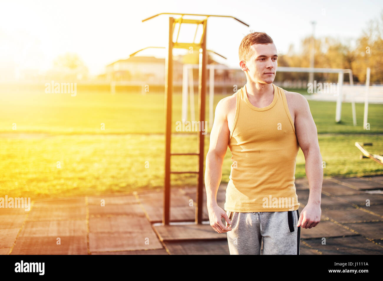 Man stand at stadium background and smile Stock Photo - Alamy