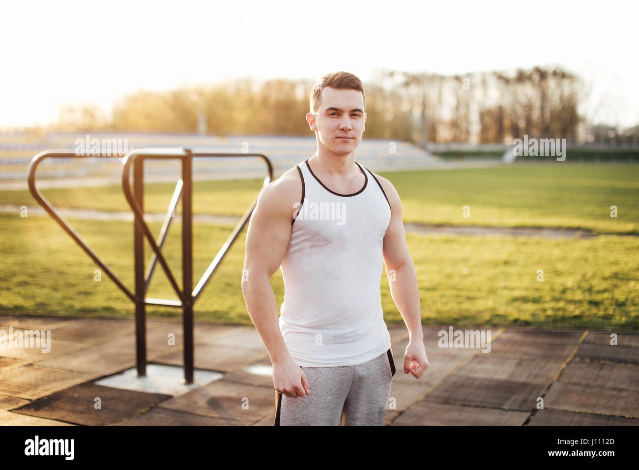 Man stand at stadium background and smile Stock Photo - Alamy
