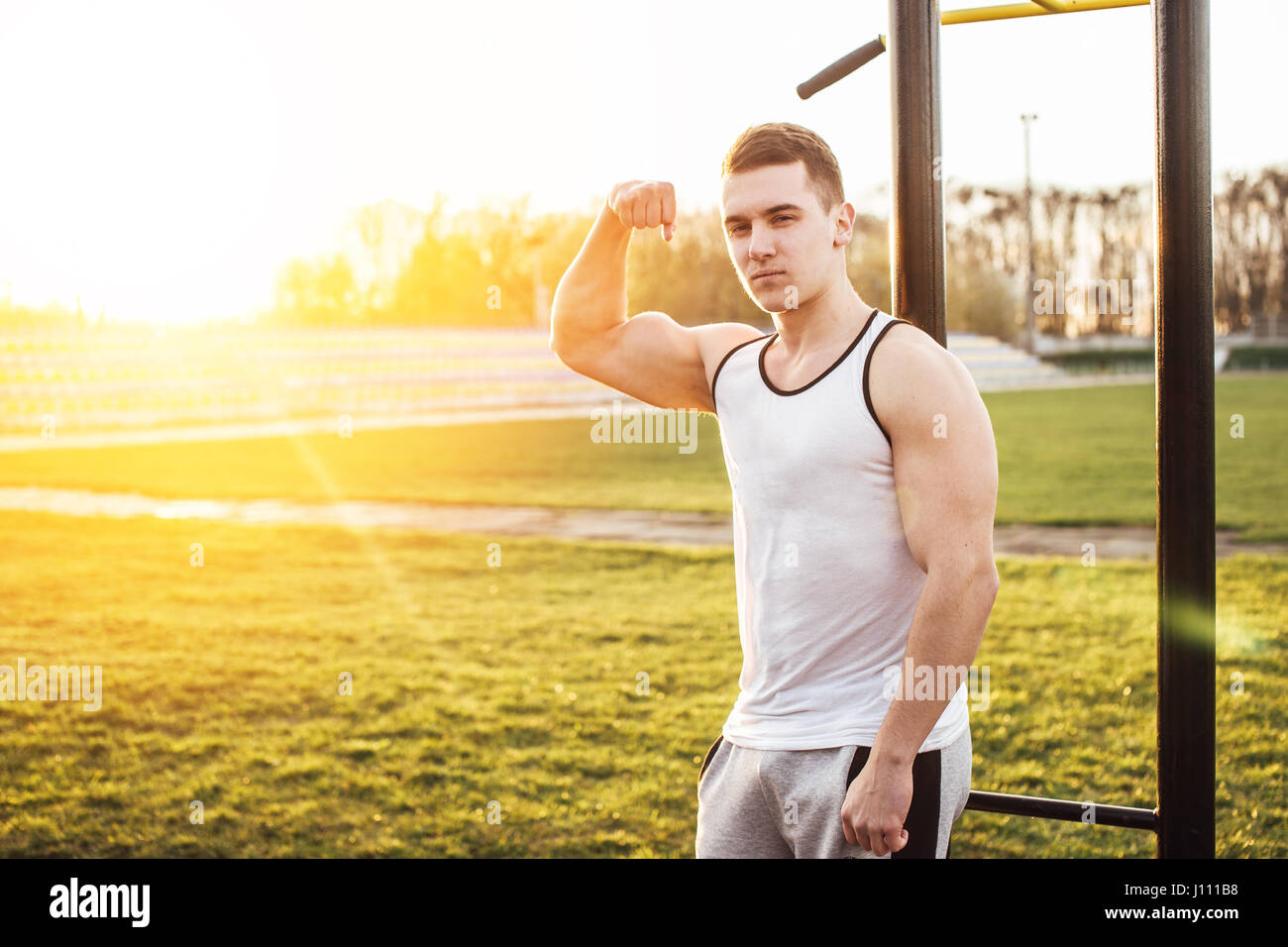 Man stand at stadium background and smile Stock Photo - Alamy
