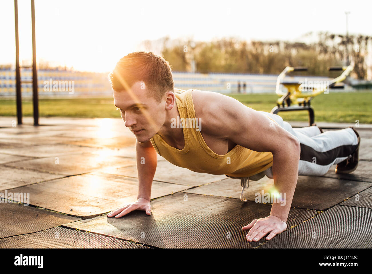 Man do workout at stadium area with sunshine background Stock Photo - Alamy