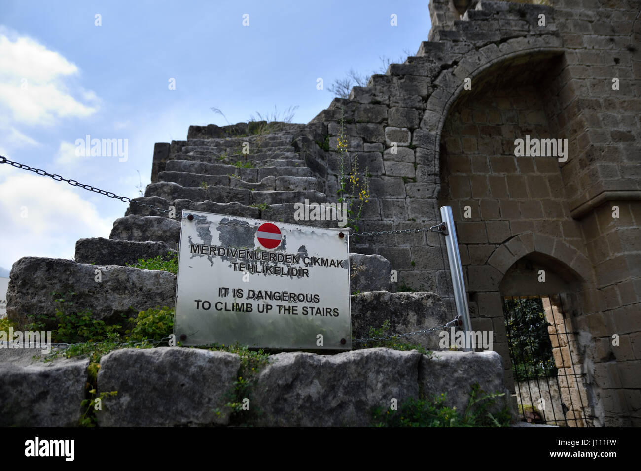 Warning sign on a old staircase of stone outside a old ruin in the ...