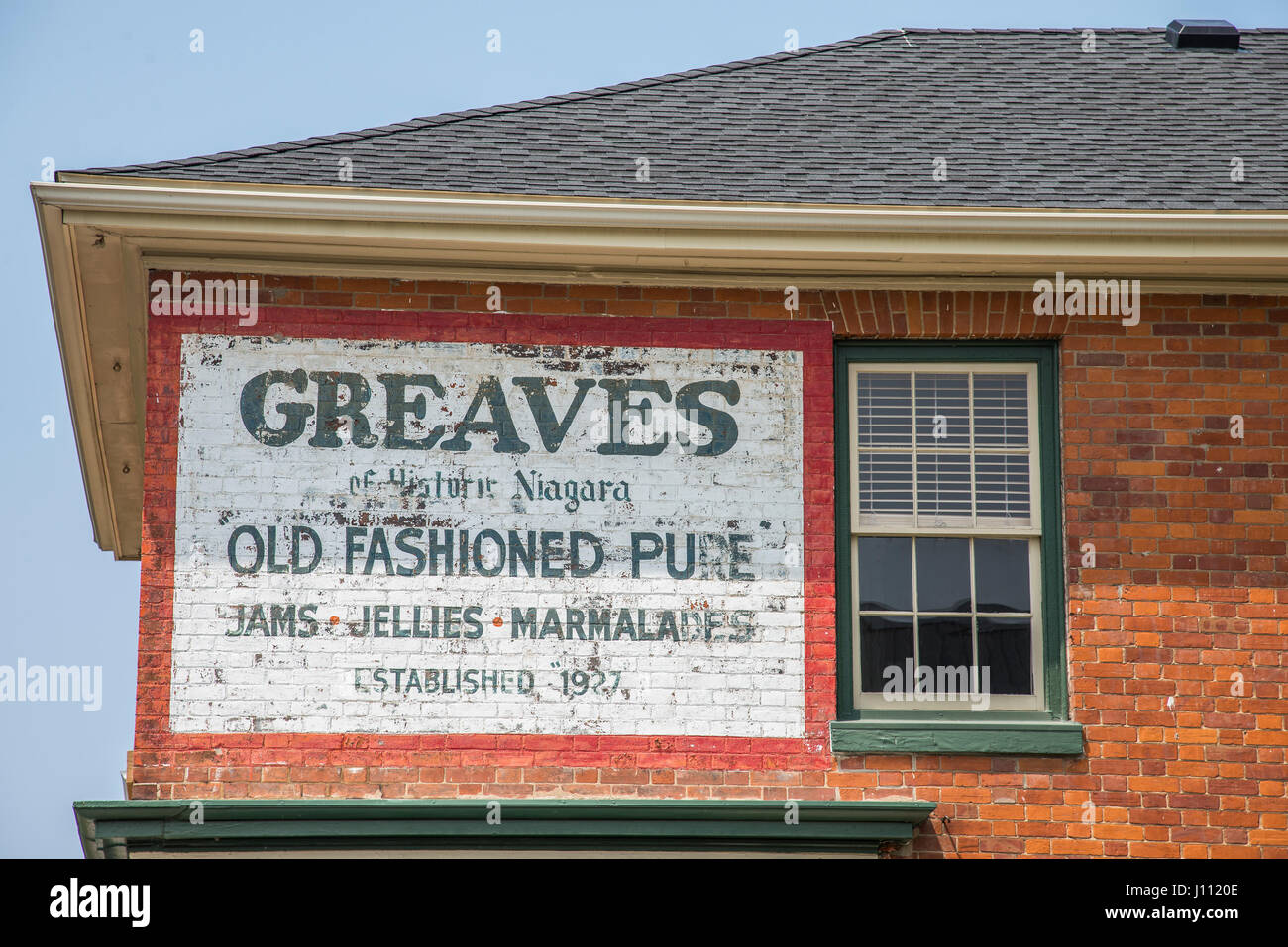 A close up of the sign painted on the red brick facade of Greaves a jam ...