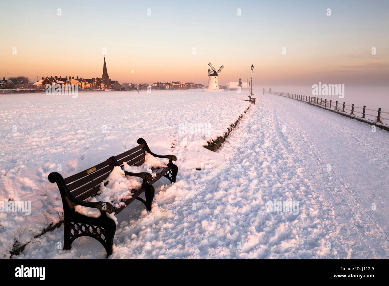Snow on the promenande in winter near the windmill in Lytham St Annes ...