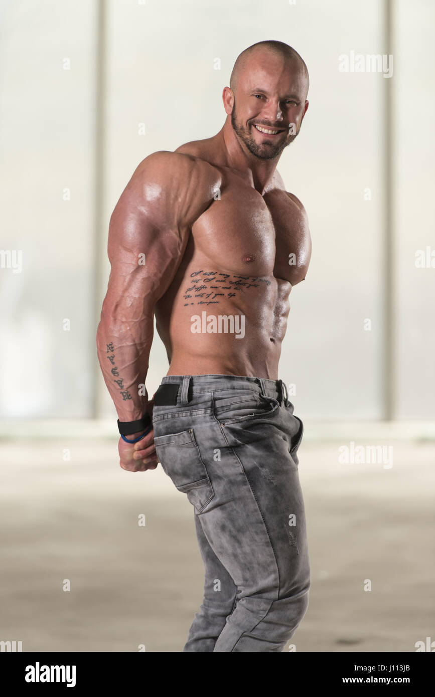 Portrait Of A Young Physically Fit Tattoo Man Showing His Well Trained