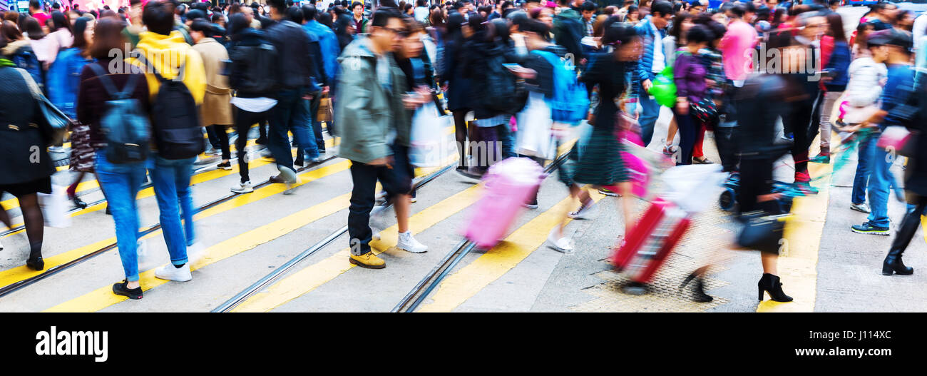 crowd of people in motion blur crossing a street in the city Stock ...