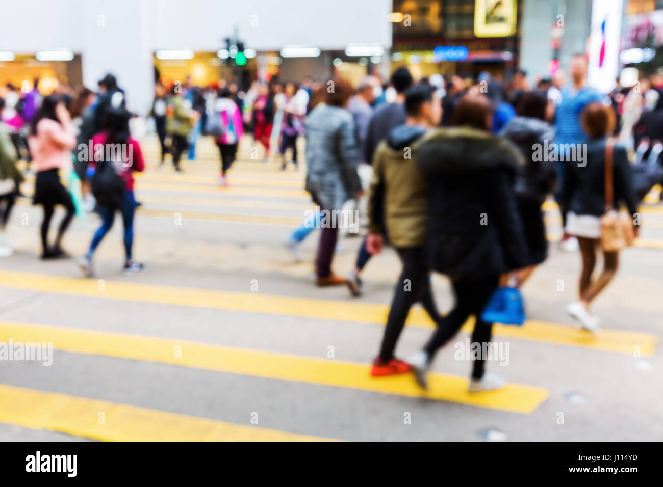 crowds of people crossing a city street out of focus Stock Photo - Alamy