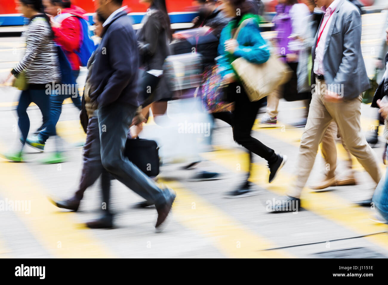 crowd of people in motion blur crossing a street in the city Stock ...
