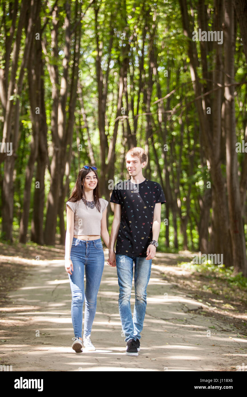 Couple taking a walk in the forest Stock Photo - Alamy