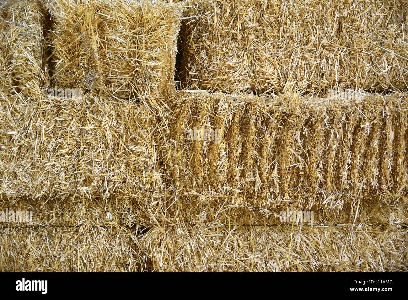 Some straw bales forming a pile in an old barn of a farm. Rural ...