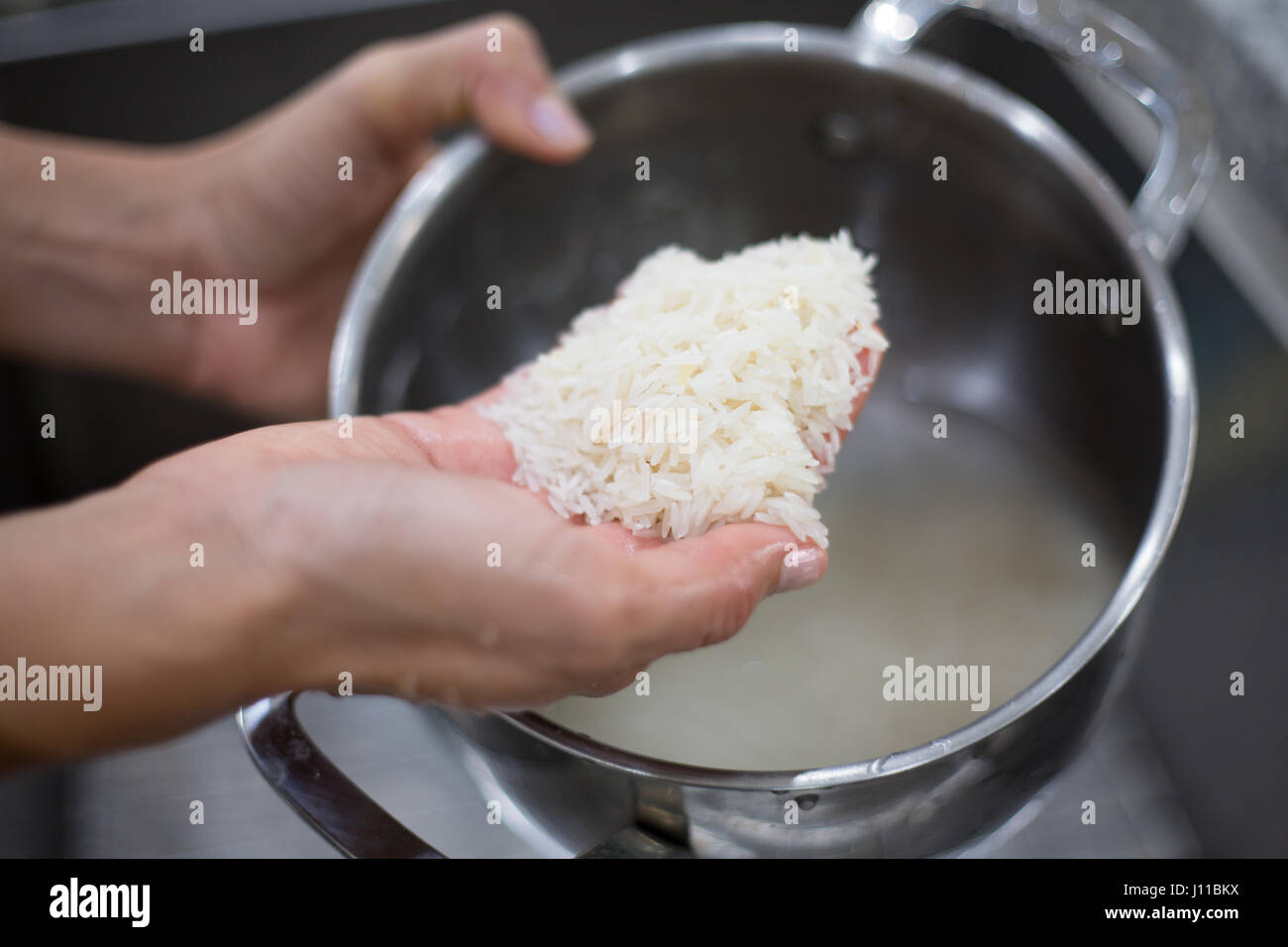 Closeup portrait of hands washing jasmine rice to free from dust and ...