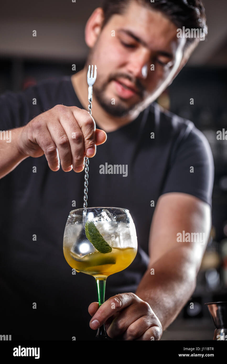 Bartender is stirring cocktails on bar counter Stock Photo - Alamy