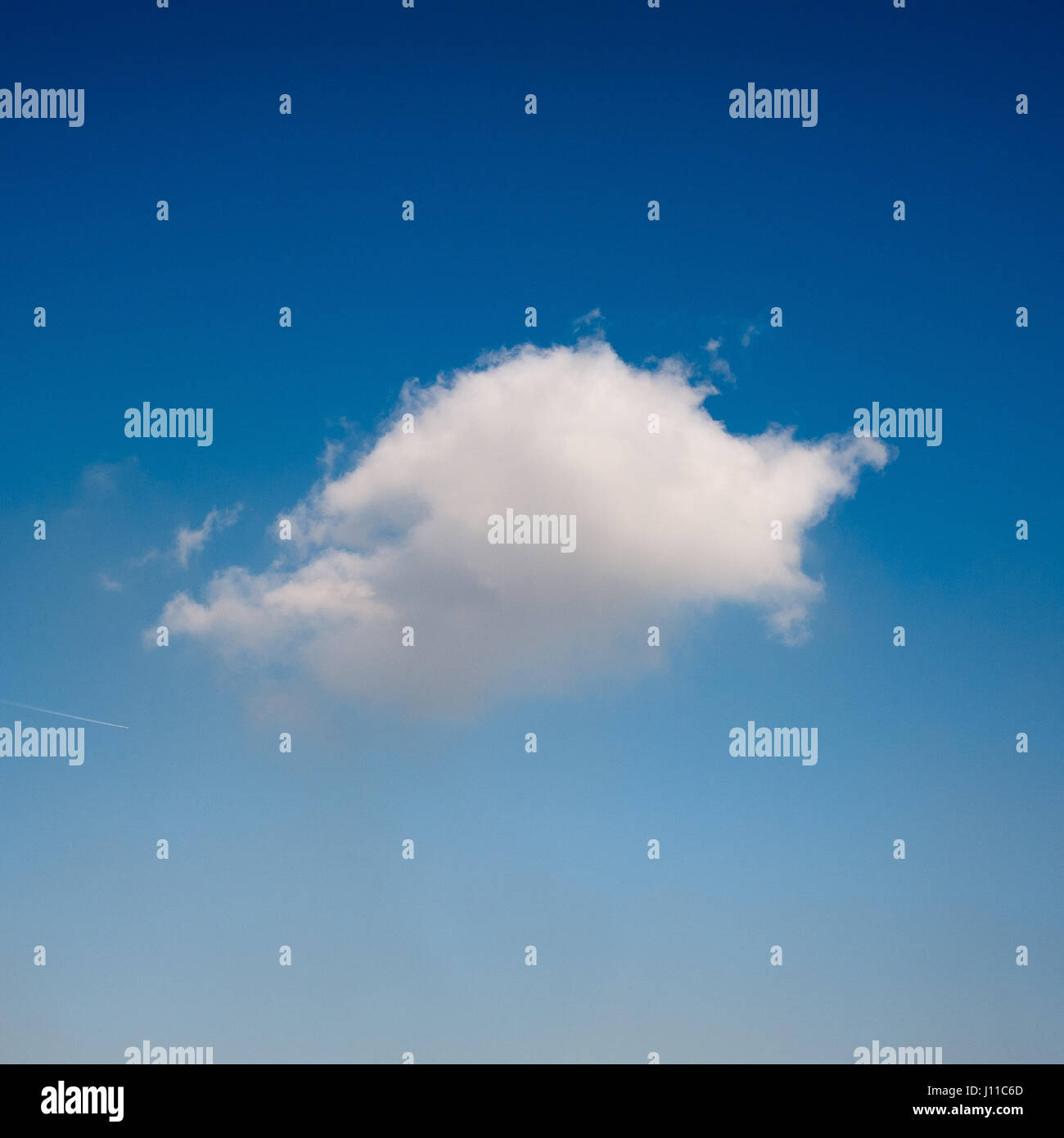 Small white cloud floating against blue sky Stock Photo - Alamy