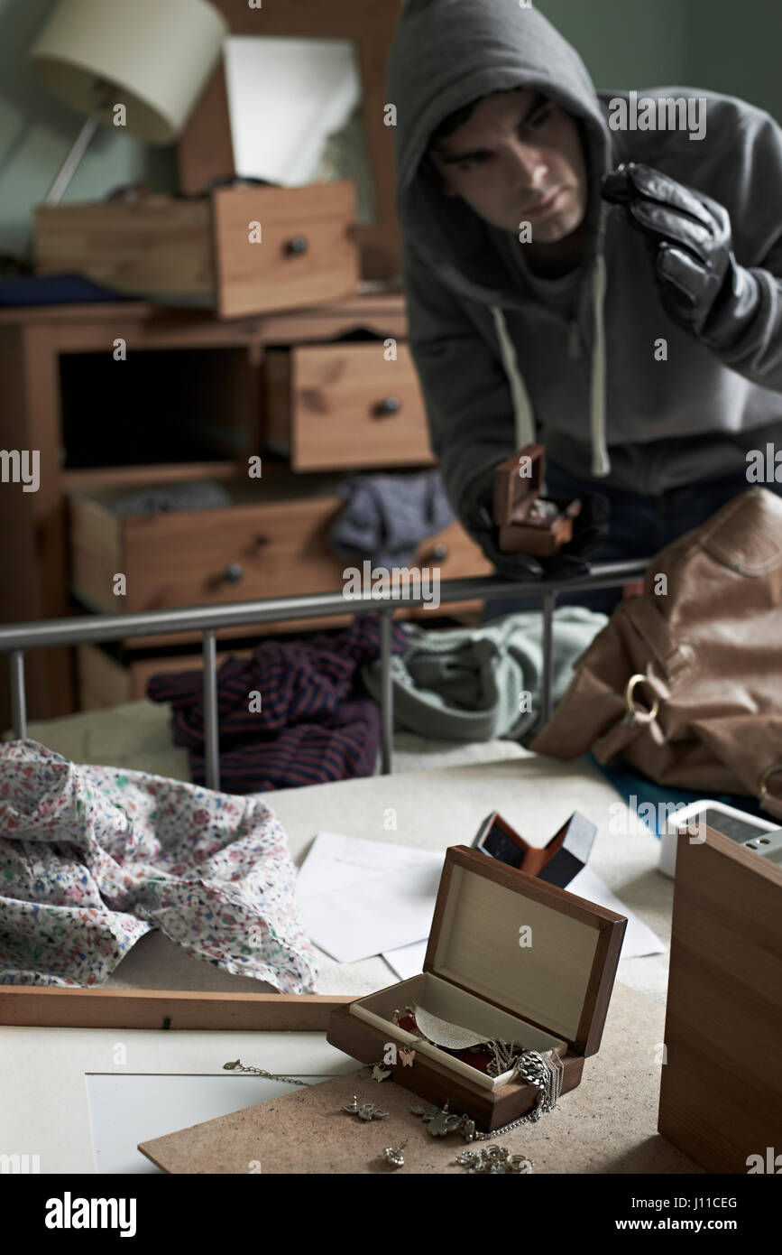 Burglar Stealing Items From Bedroom During Hose Break In Stock Photo ...