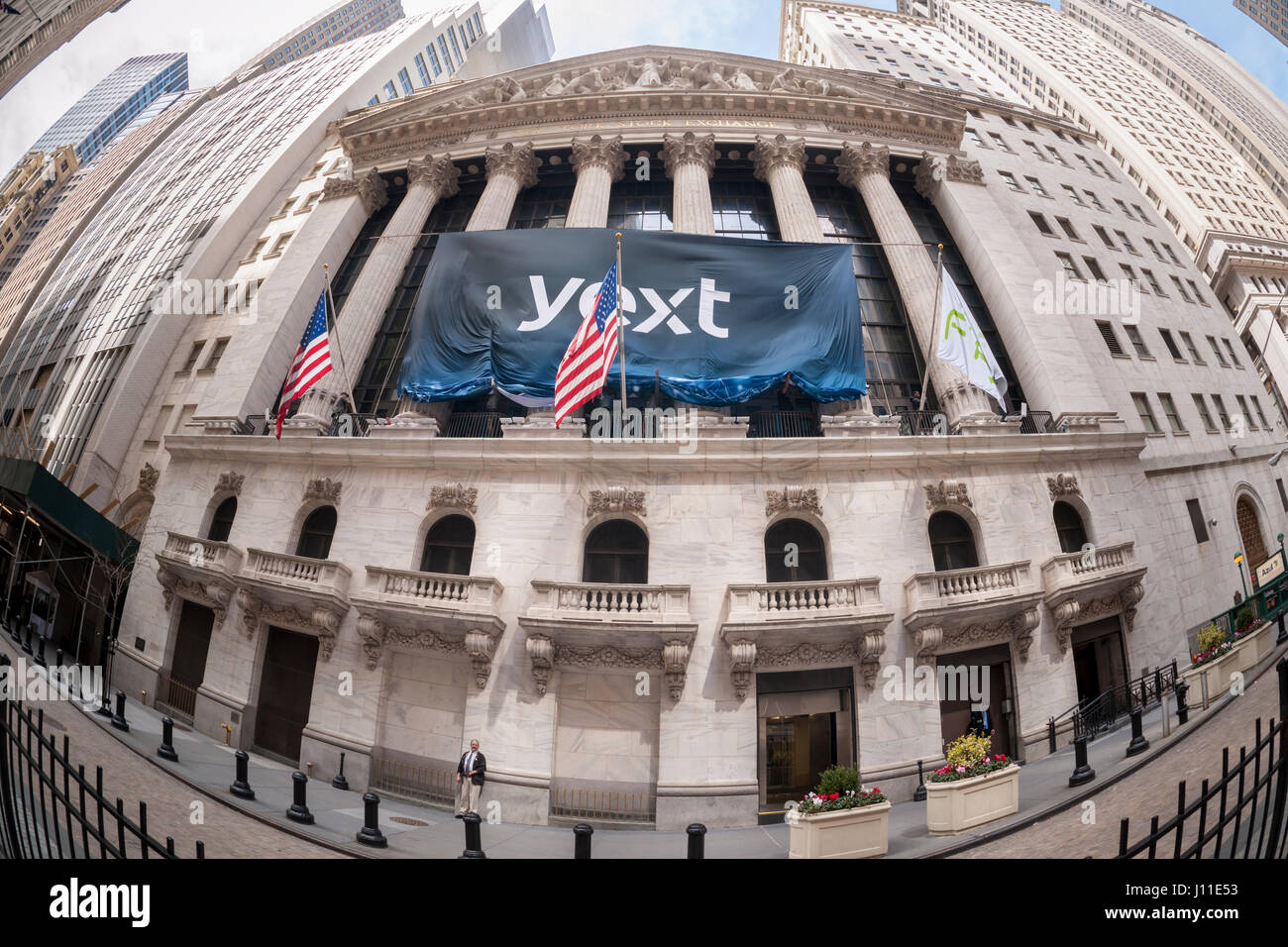 New York Stock Exchange workers remove the banner for the initial ...