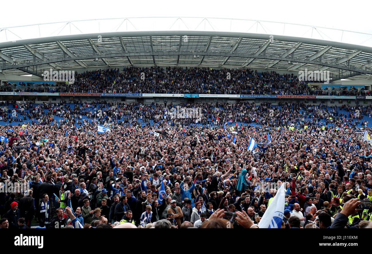 Brighton and Hove Albion fans celebrate promotion on the pitch ...