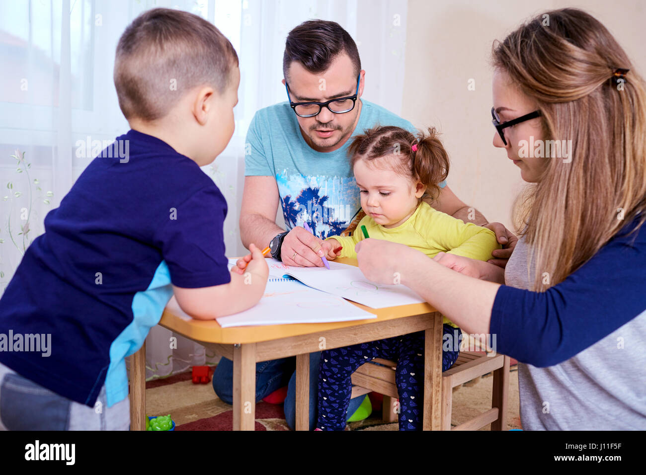 Parents and children draw together in the room Stock Photo - Alamy