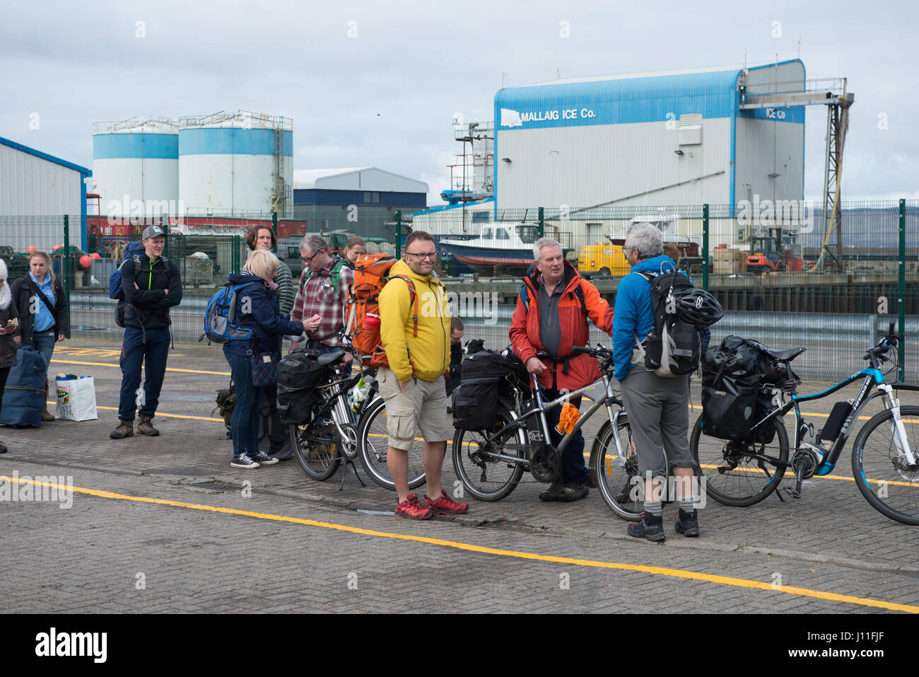 Cyclist waiting to board the Cal Mac Ferry Lochnevis to the Islands of ...