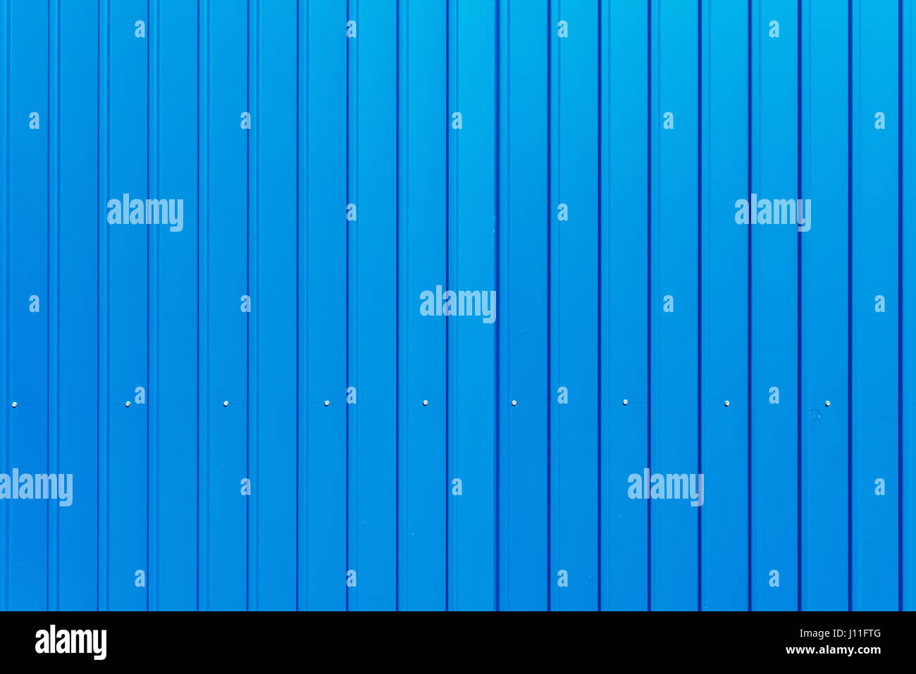 Blue warehouse wall, metal plated surface of storage building facade ...