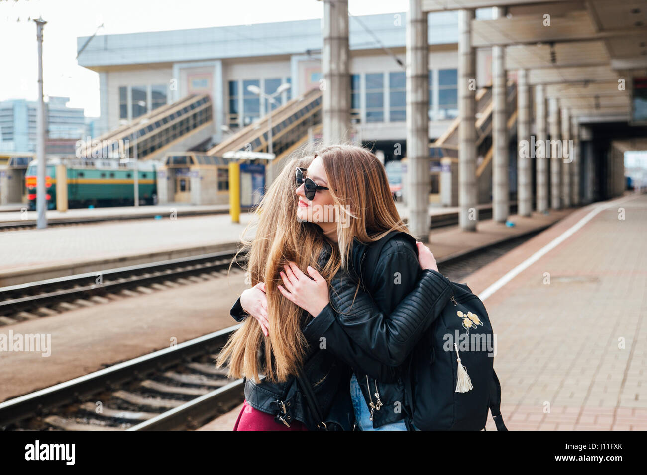 Happy meeting two friends hugging hi-res stock photography and images ...