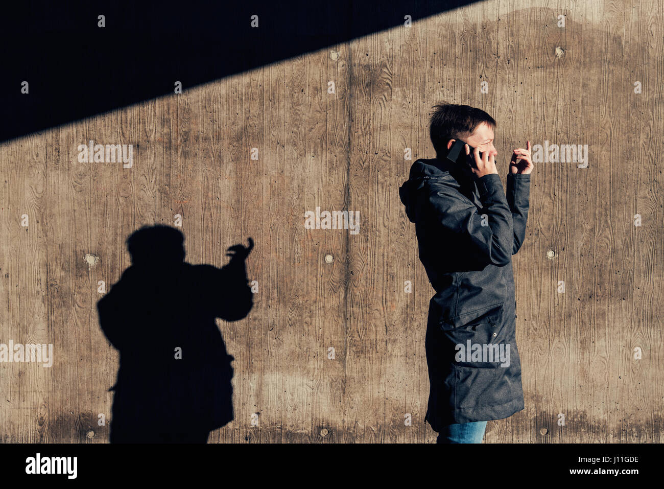 Serious authentic woman with short hair talking on mobile phone on the ...
