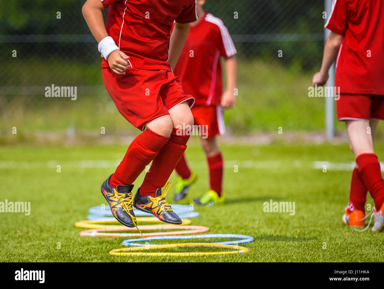 Young Soccer Player Practicing on the Pitch. Soccer Football Equpment ...
