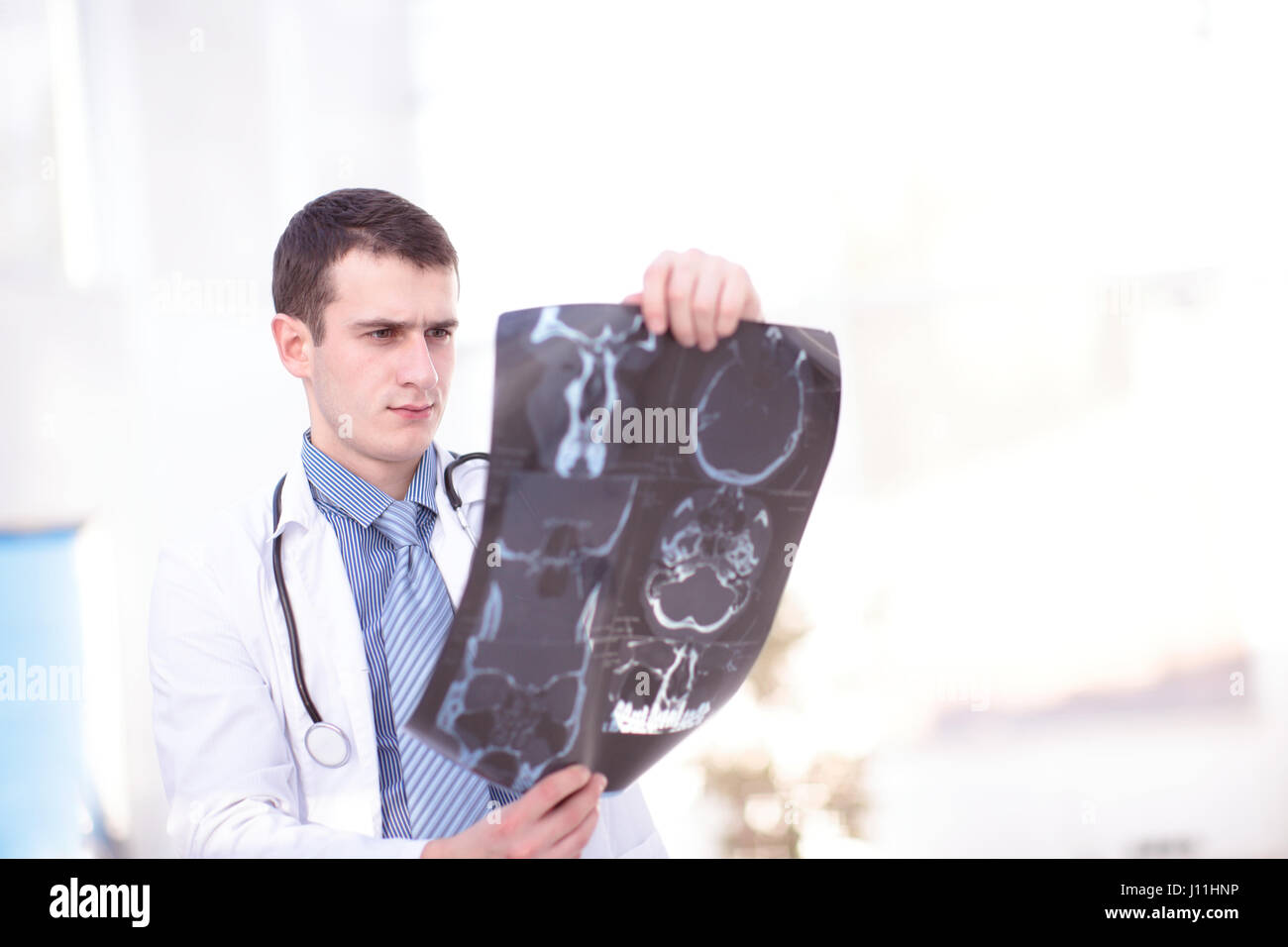 Medical doctor looking at a x-ray image Stock Photo - Alamy