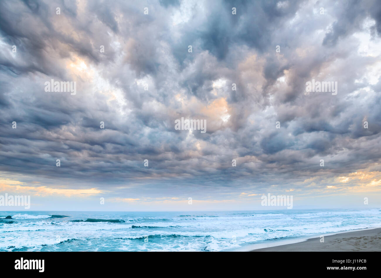 Cloudy sea sunset Stock Photo - Alamy