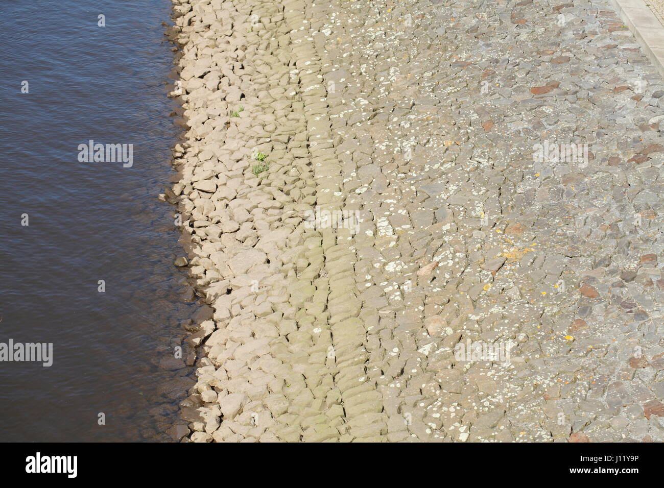 Stones on a river embankment Stock Photo - Alamy