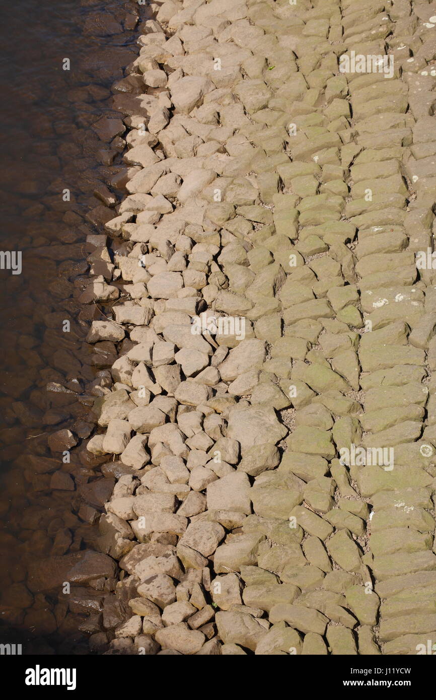 Stones on a river embankment Stock Photo - Alamy