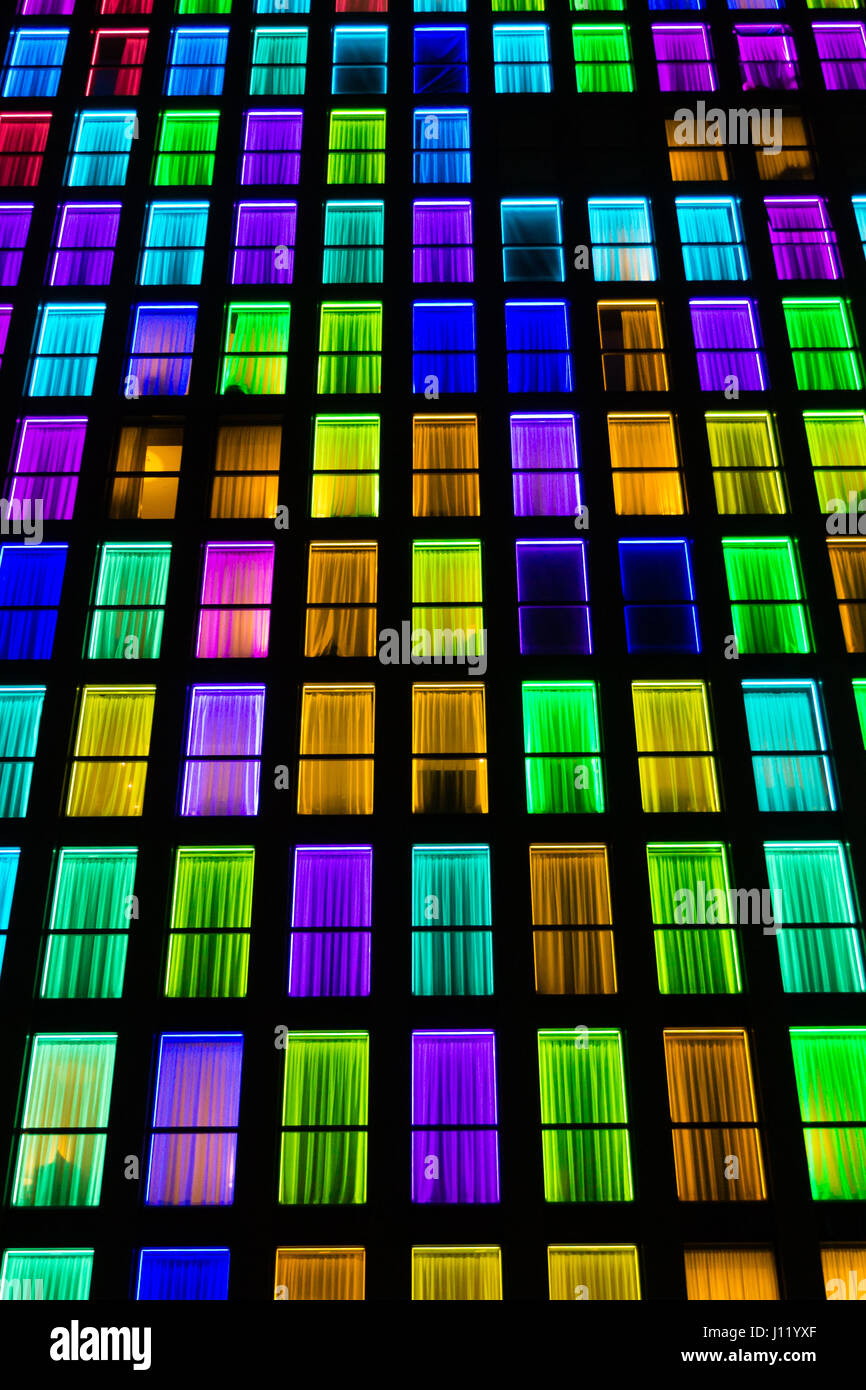 Colored windows texture. Windows illuminated by neon lights background ...