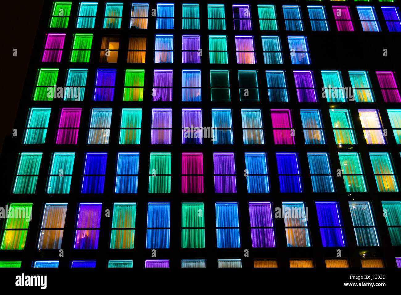 Colored windows texture. Windows illuminated by neon lights background ...