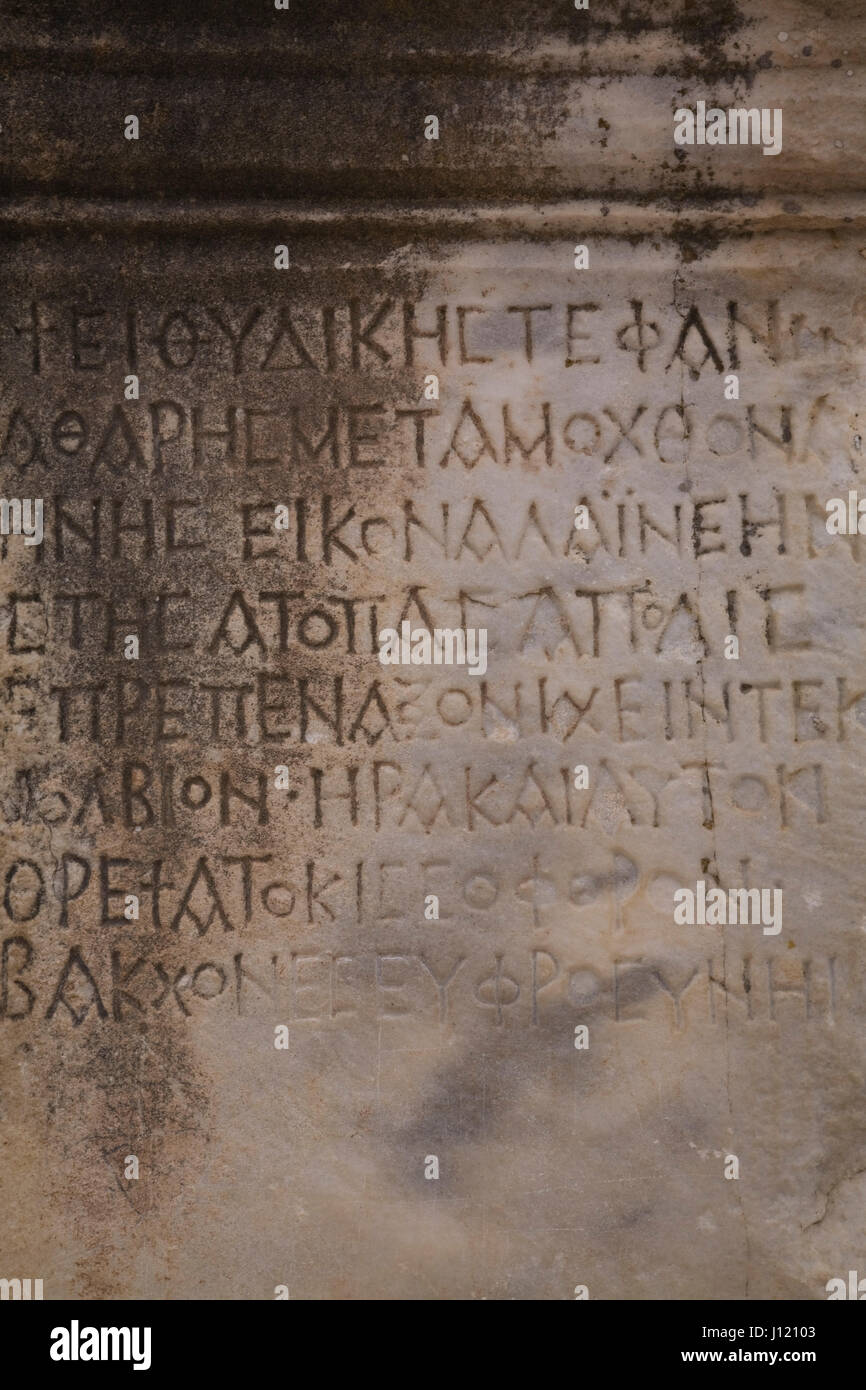 Greek inscription on a marble column at the ancient ruins of Ephesus ...