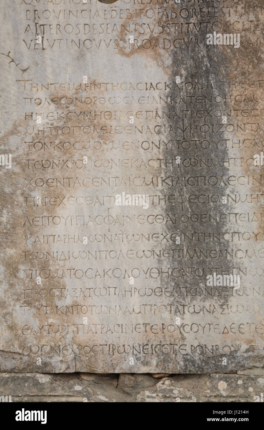Greek inscription on a marble column at the ancient ruins of Ephesus ...