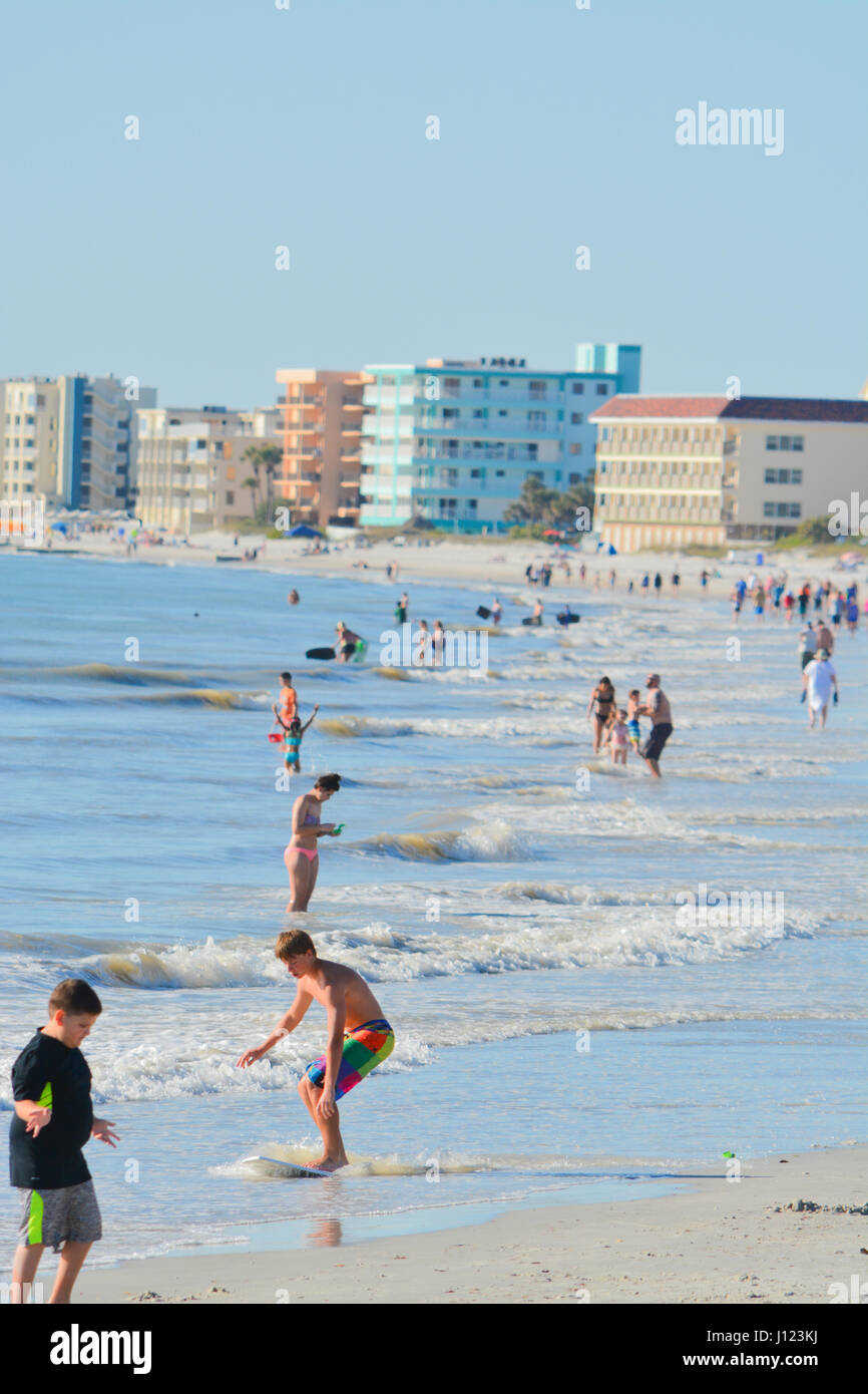 Beach Goers walking the white sands of Madeira Beach, Florida on the ...