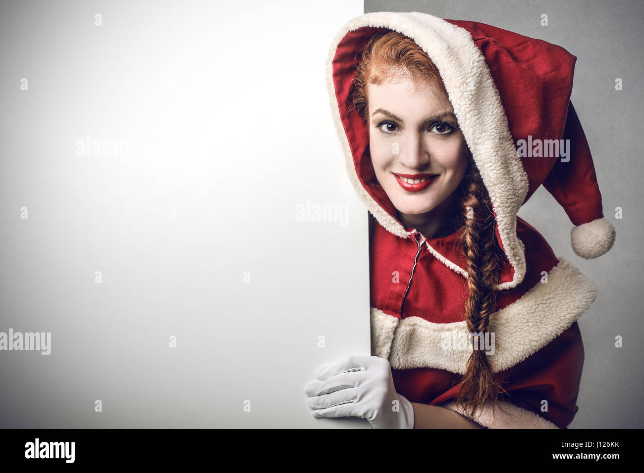 Santa sneaking looking into camera Stock Photo - Alamy