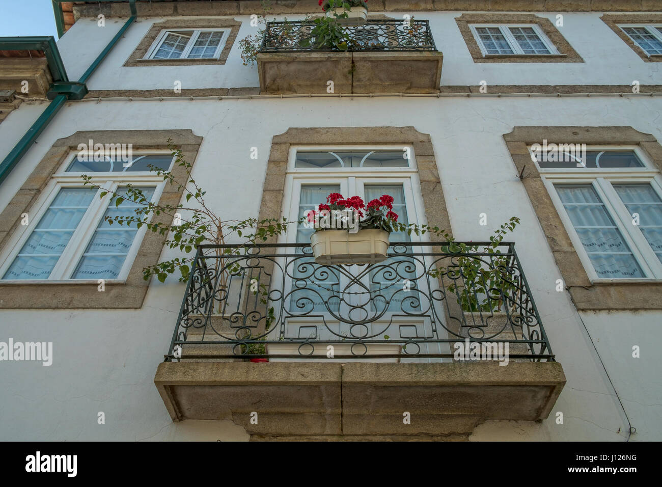 Facade of a typical portuguese building with flowers on window Stock ...