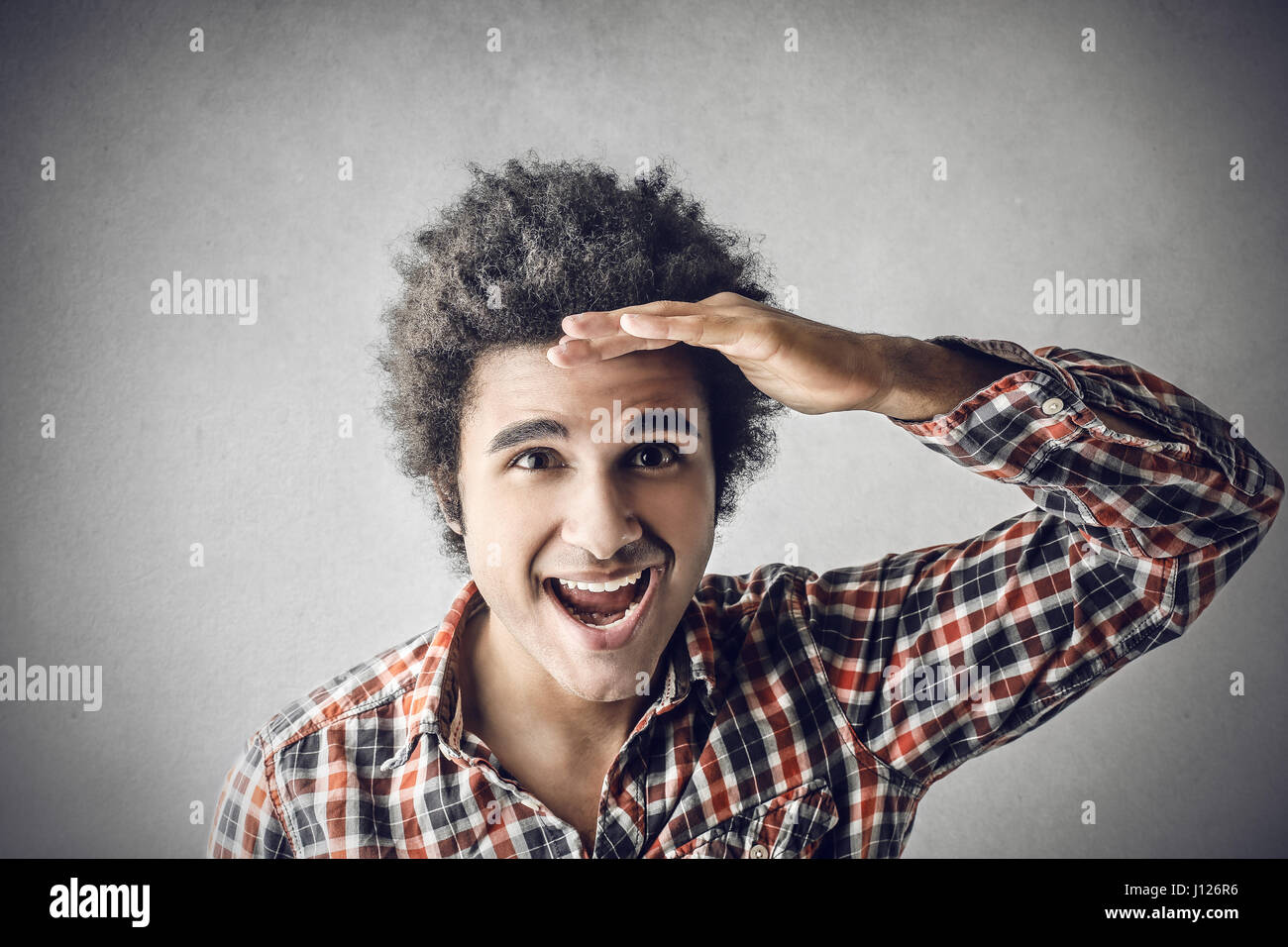 Young man looking in the distance Stock Photo - Alamy