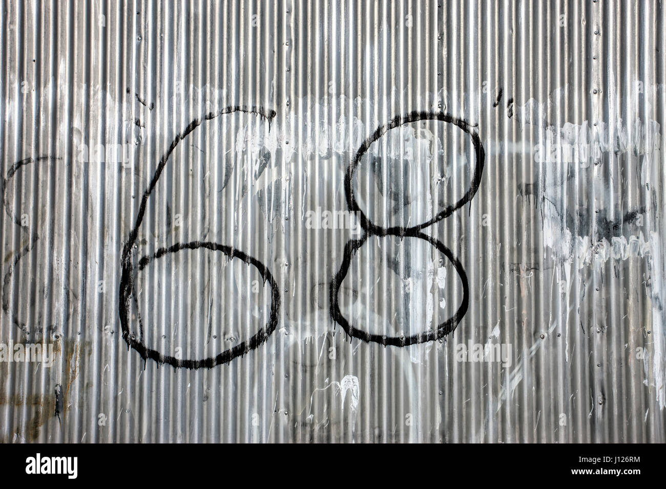 The number 68 spray painted on the side of an old metal wall Stock ...