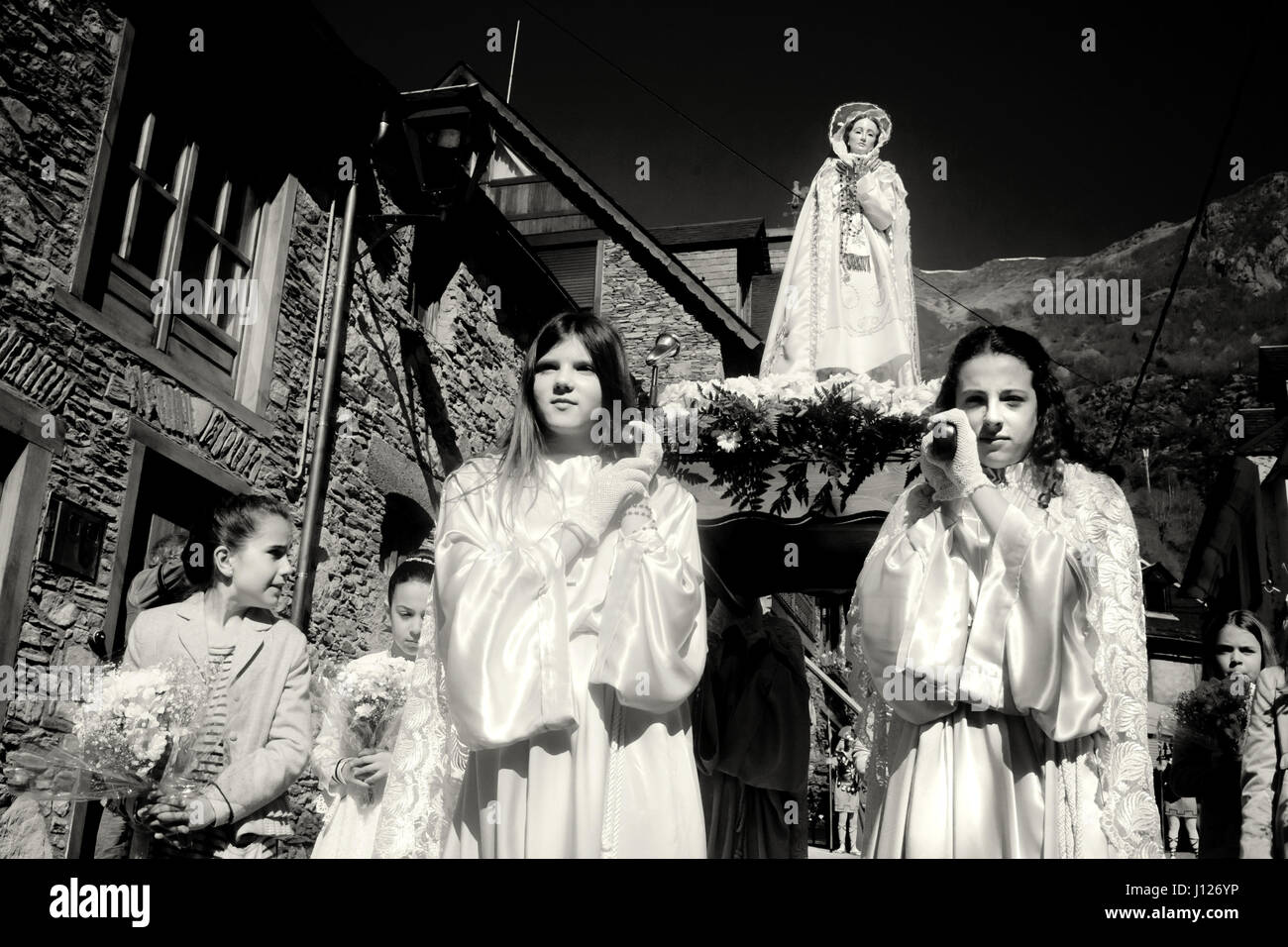 Children carrying a wooden image representing the Virgin Mary take part ...
