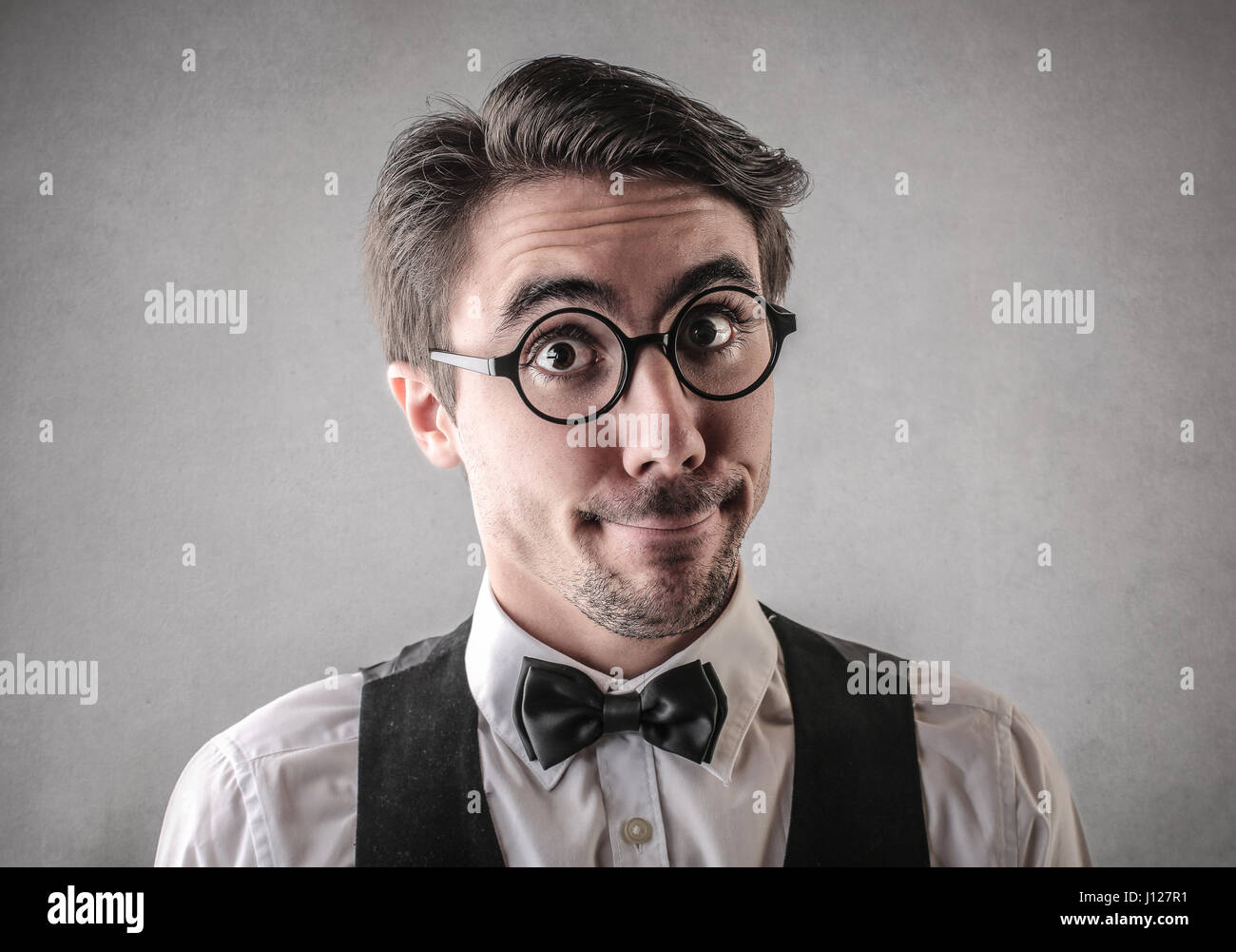 Portrait of suspicious elegant man Stock Photo - Alamy