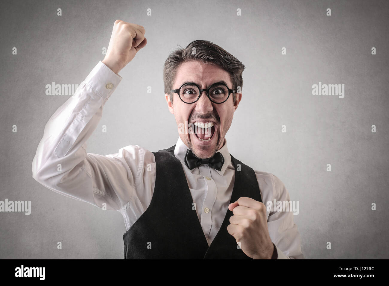 Happy elegant man cheering inside Stock Photo - Alamy