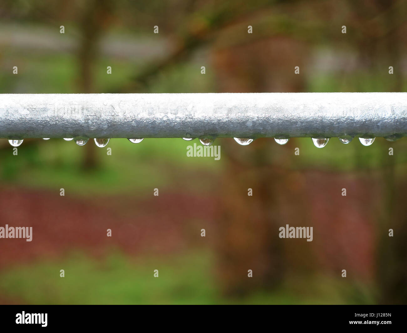 Raindrops on fence rail Stock Photo - Alamy