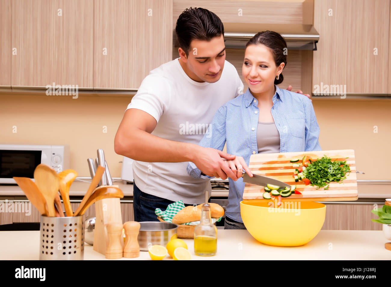 Young family in the kitchen Stock Photo - Alamy
