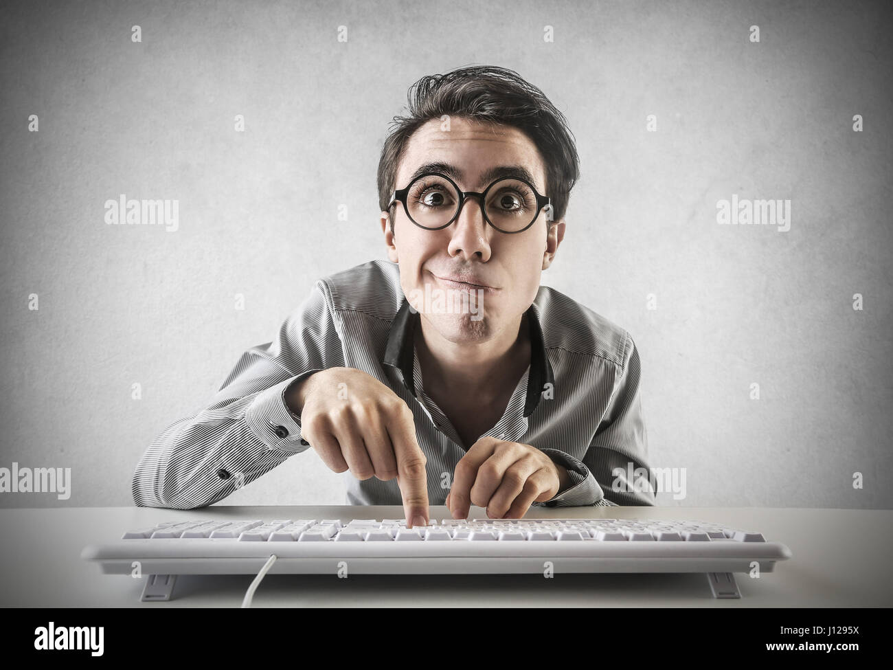 Businessman in glasses typing in front of computer Stock Photo - Alamy
