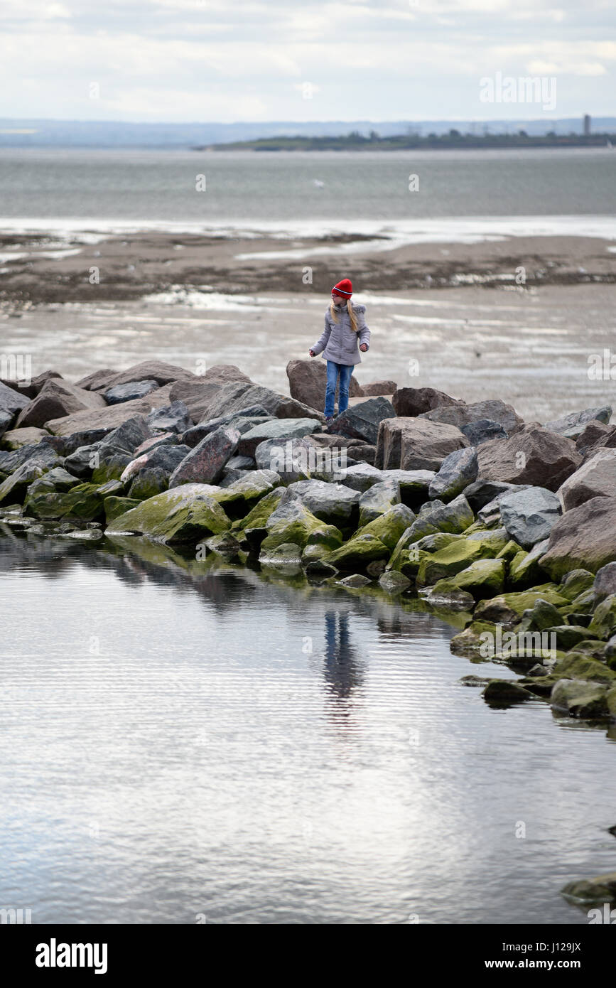 Child playing on the rocks bordering the Three Shells Beach Lagoon on ...