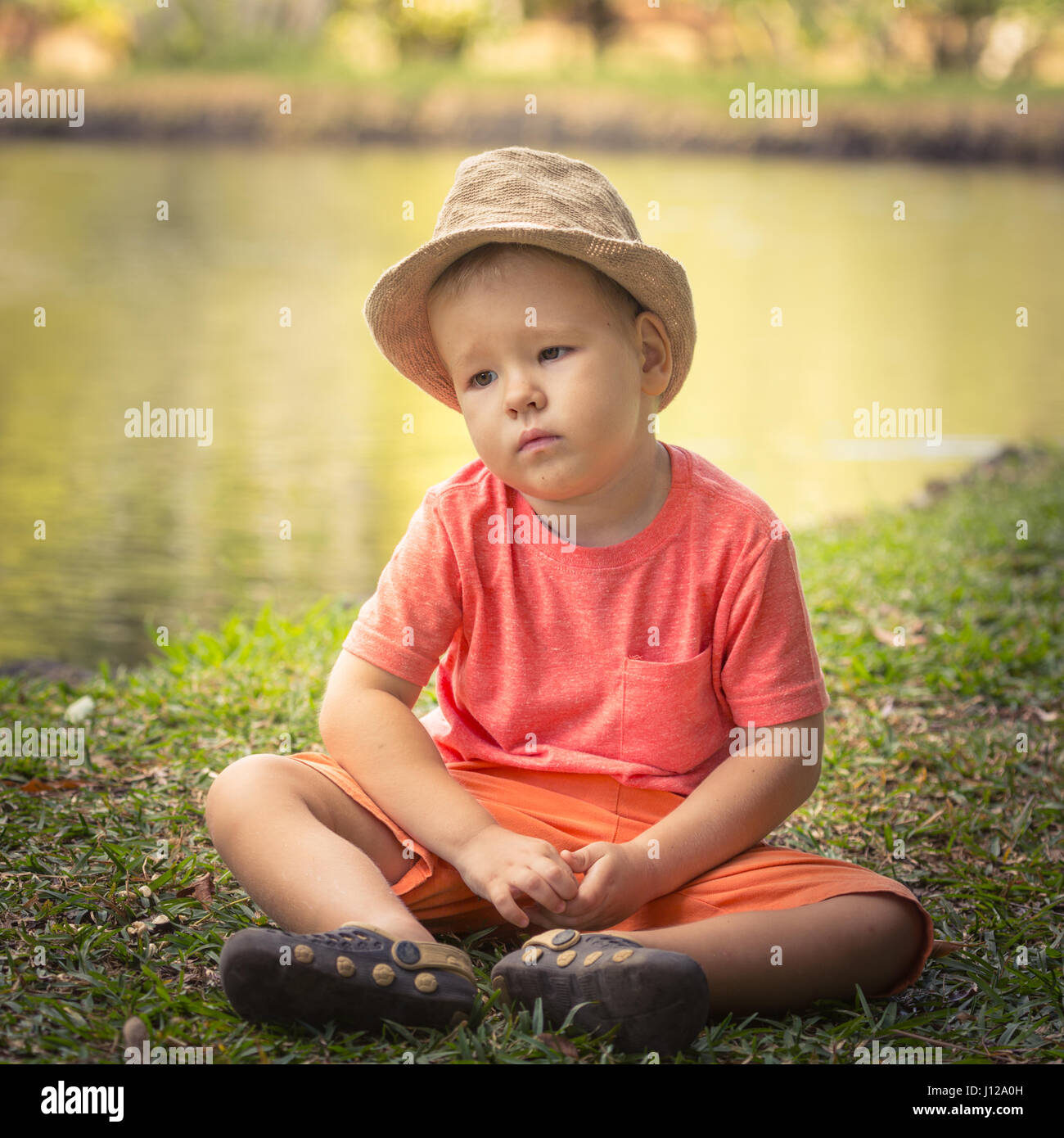 Boy at lakeside at botanical garden. Mauritius Stock Photo - Alamy