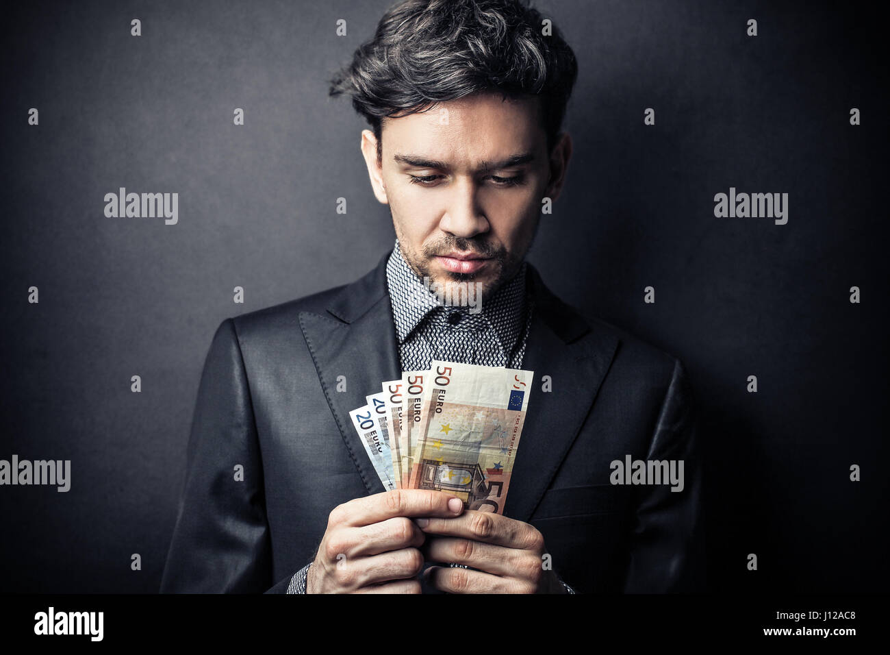 Businessman counting money Stock Photo - Alamy